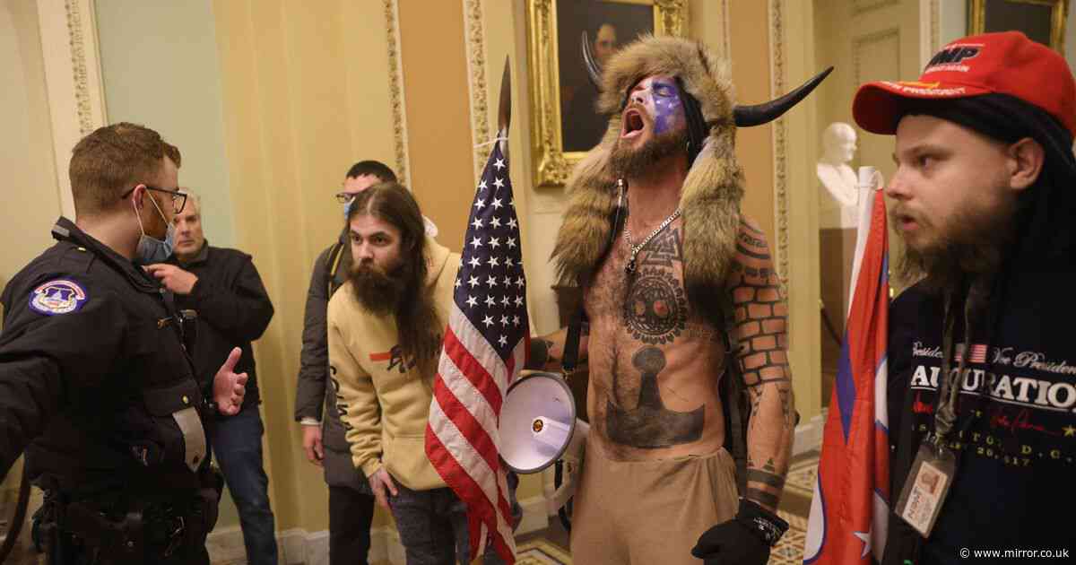 'QAnon Shaman' poses triumphantly in US Senate as Trump rioters storm ...